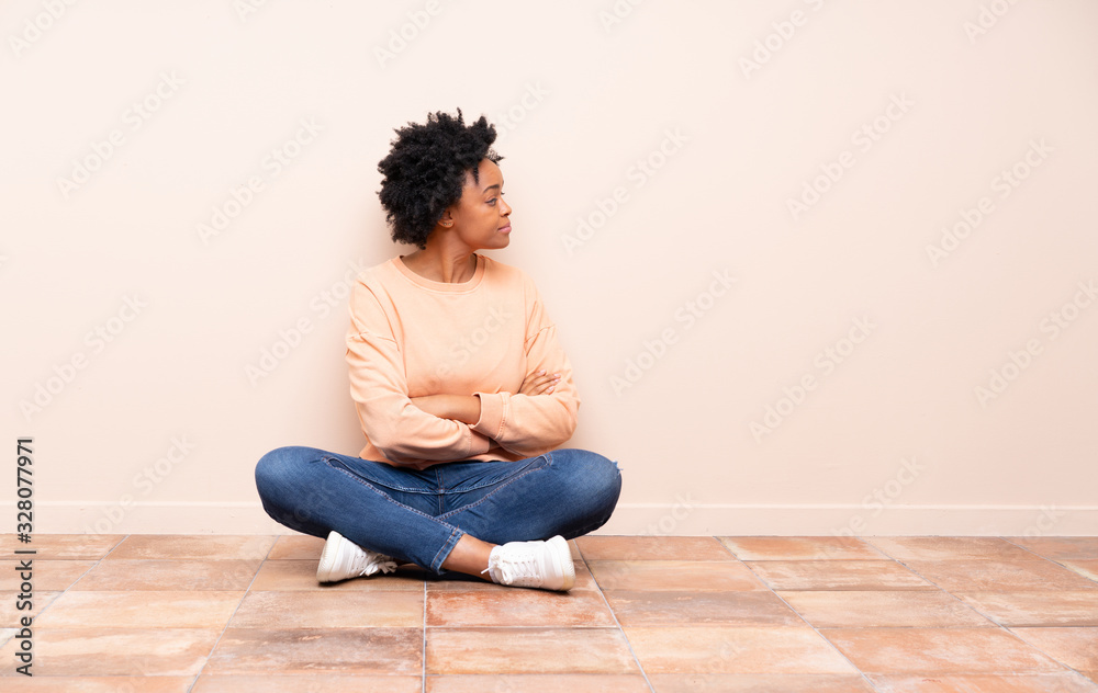 African american woman sitting on the floor in lateral position Stock ...