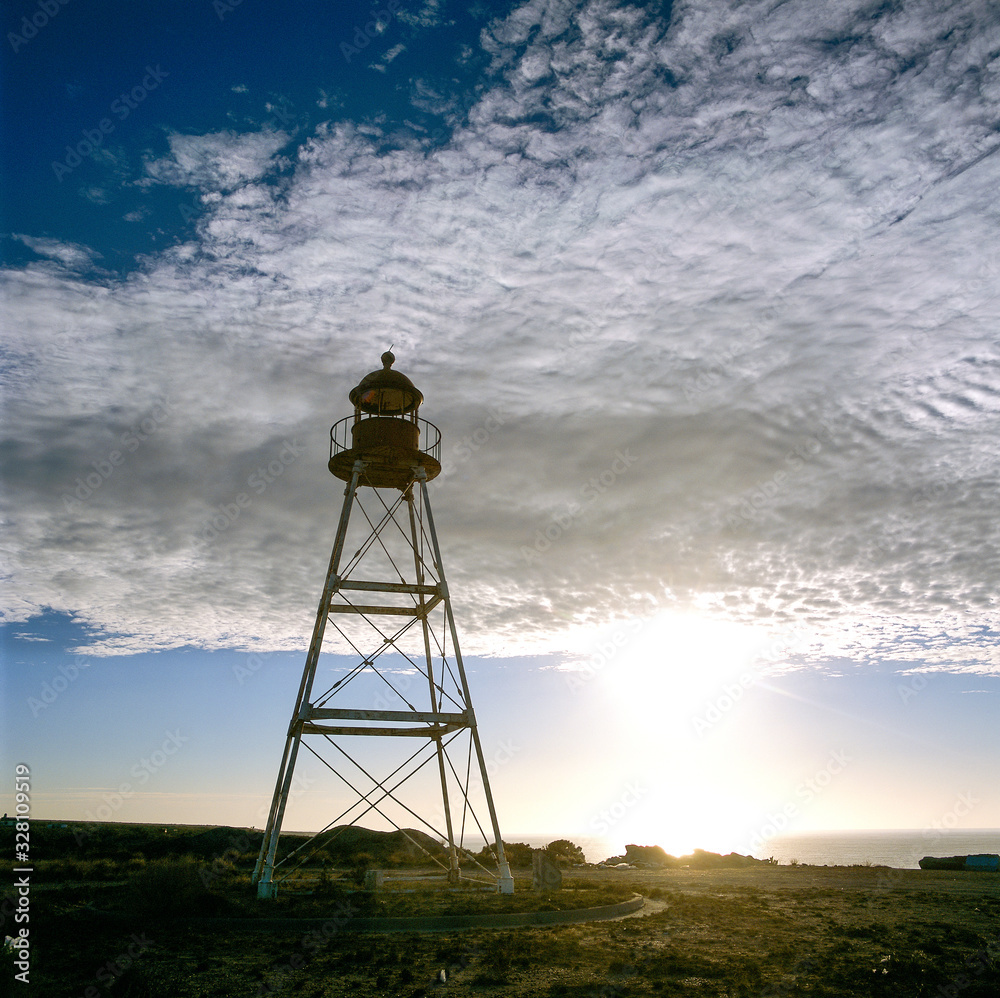 A lighthouse is a tower, designed to emit light from a system of lamps ...