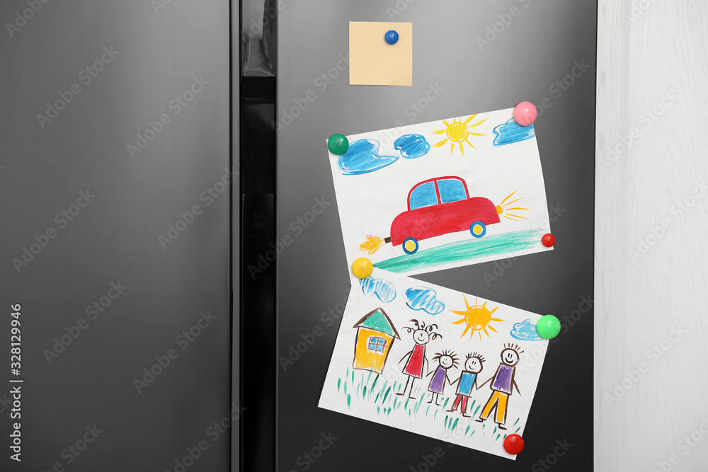 Modern refrigerator with child's drawings and magnets Stock Photo ...