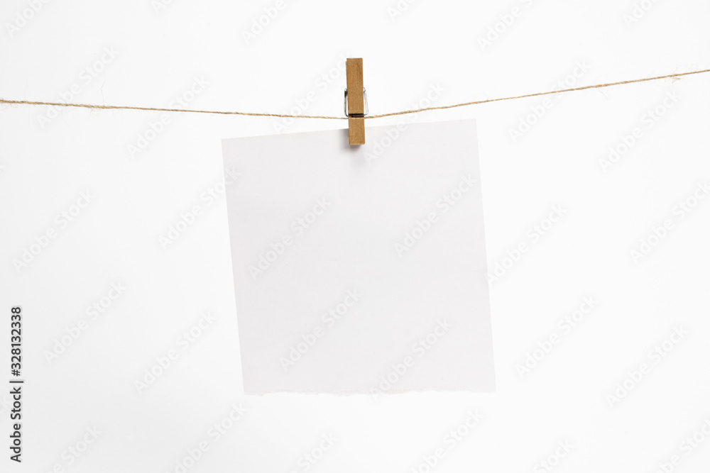 Single empty paper sheet for notes that hang on a rope with clothespins ...