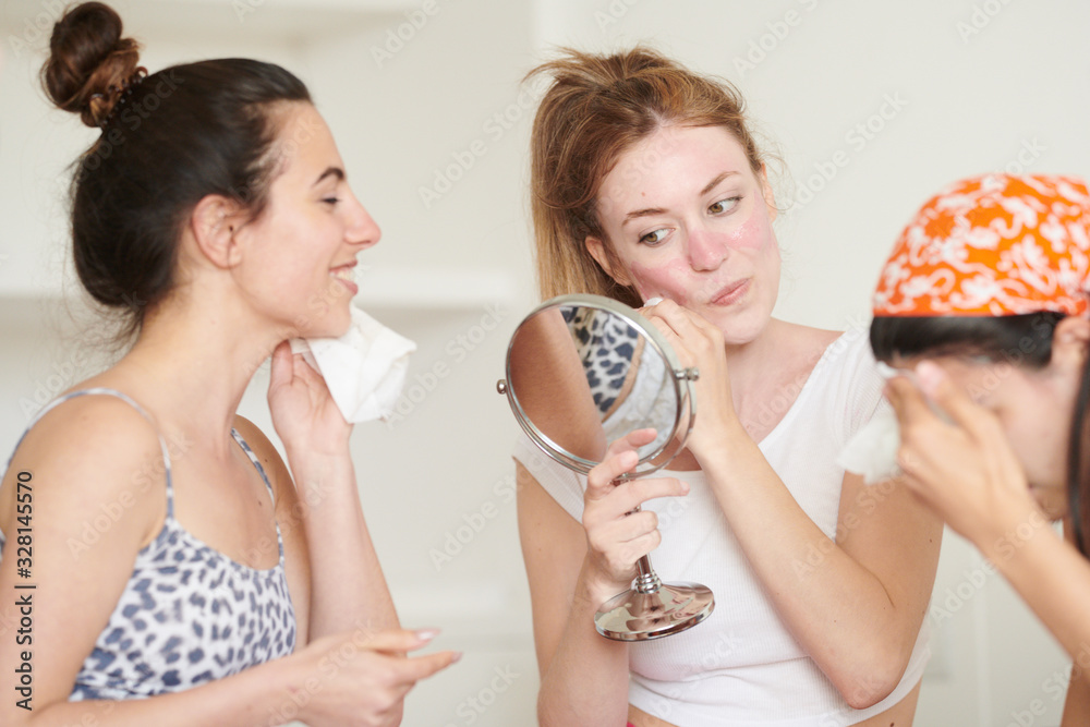 Beautiful women wiping off makeup with wet facial tissues Stock-Foto ...