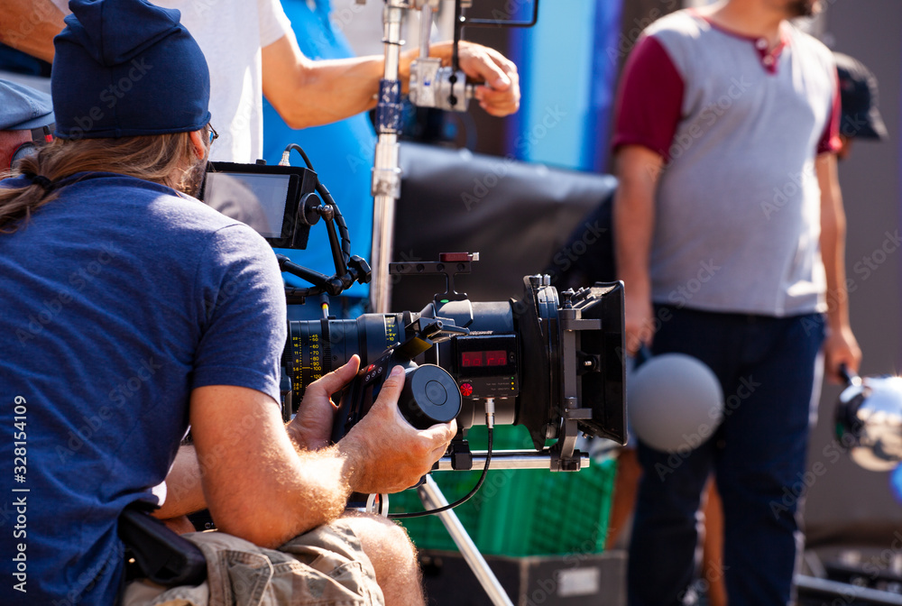 Focus puller hold the wireless follow focus system during the filming ...