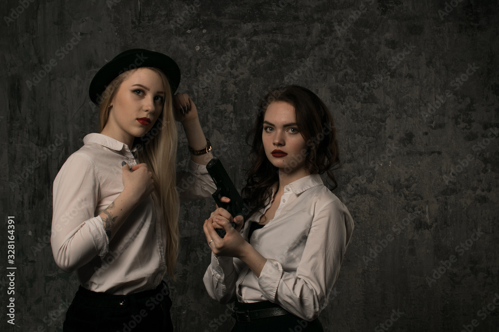 Two girls in white shirts with a gun noir style portraits. Models ...
