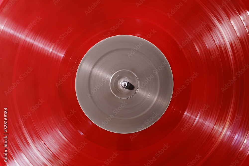 Red vinyl record rotate. Ray of light piece of vinyl. Turntable player ...
