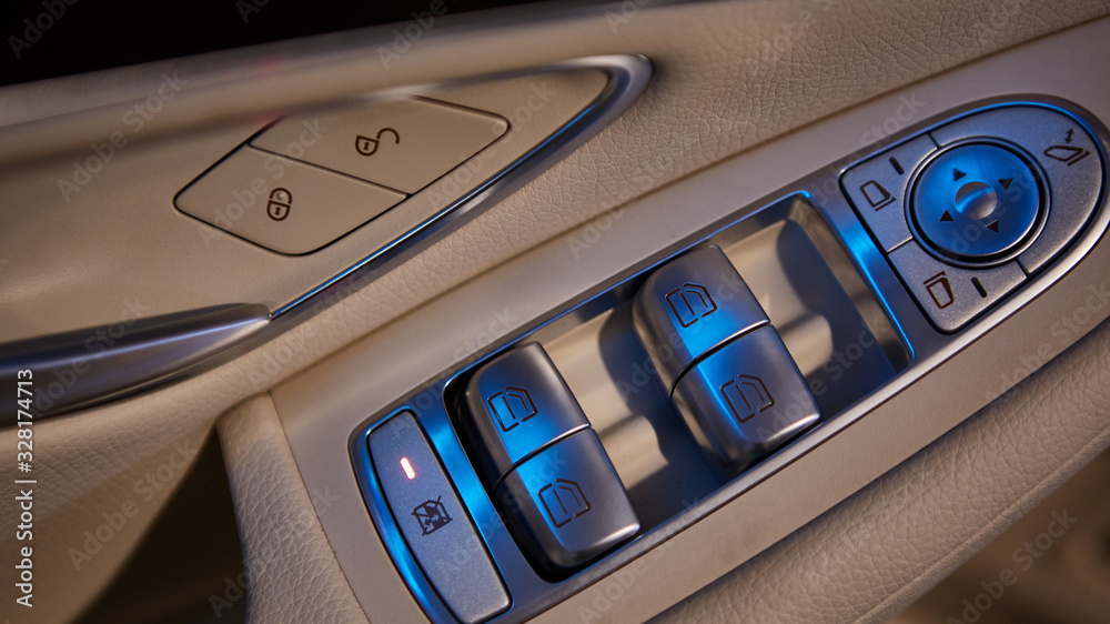 car interior details of door handle with windows controls and ...