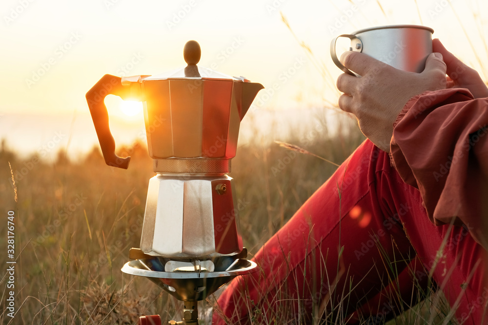 Woman tourist is drinking hot coffee from cup with coffee pot on ...