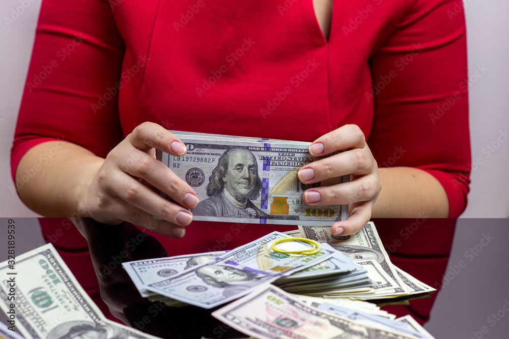 Woman in red dress holding and counting cash money (american dollars ...
