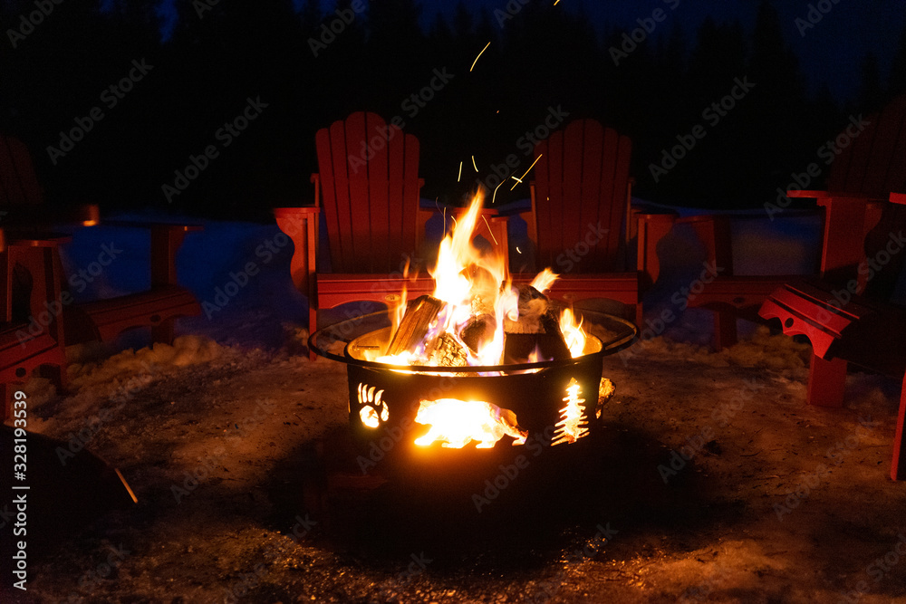 Cozy/romantic evening scene of warming bonfire on snow in winter with ...