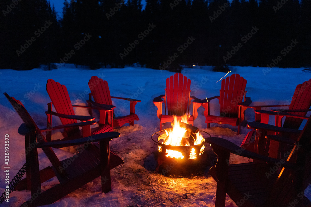 Cozy/romantic evening scene of warming bonfire on snow in winter with ...