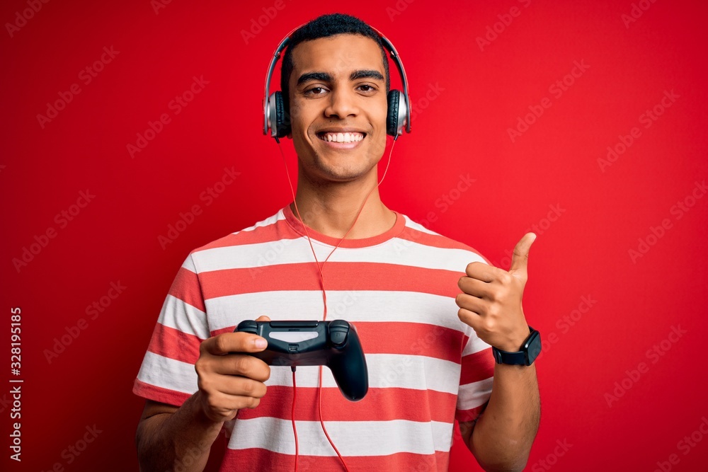 Handsome african american gamer man playing video game using jostick ...