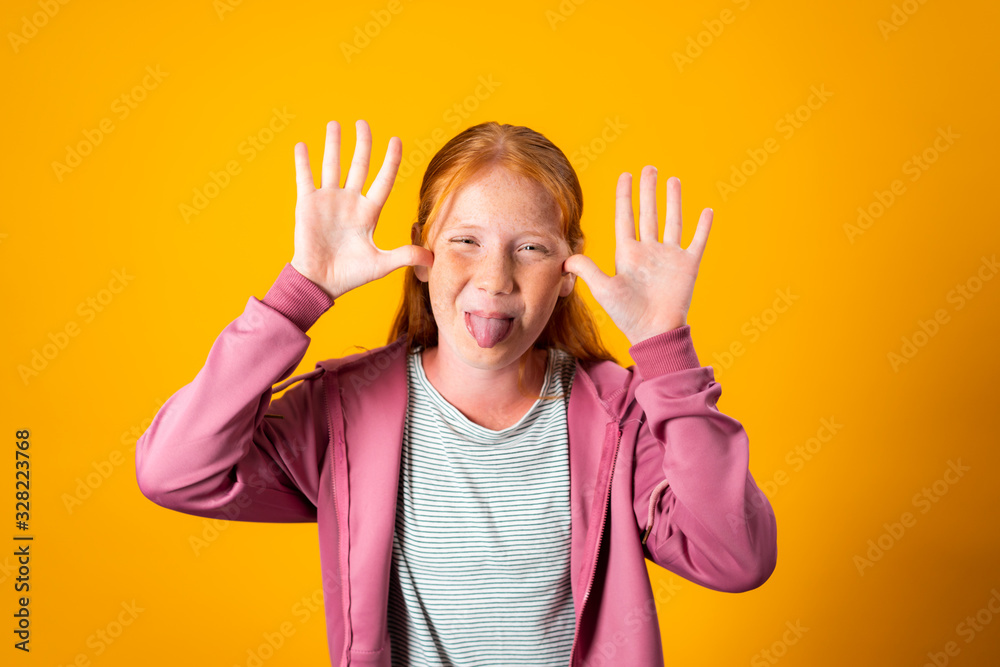 Red hair girl taunting and mocking while sticking tongue out. Stock ...