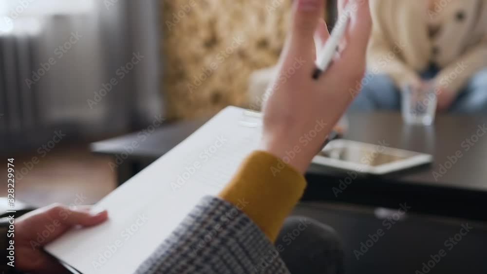 Front view of elegant man's hand which holding the folder with notes ...