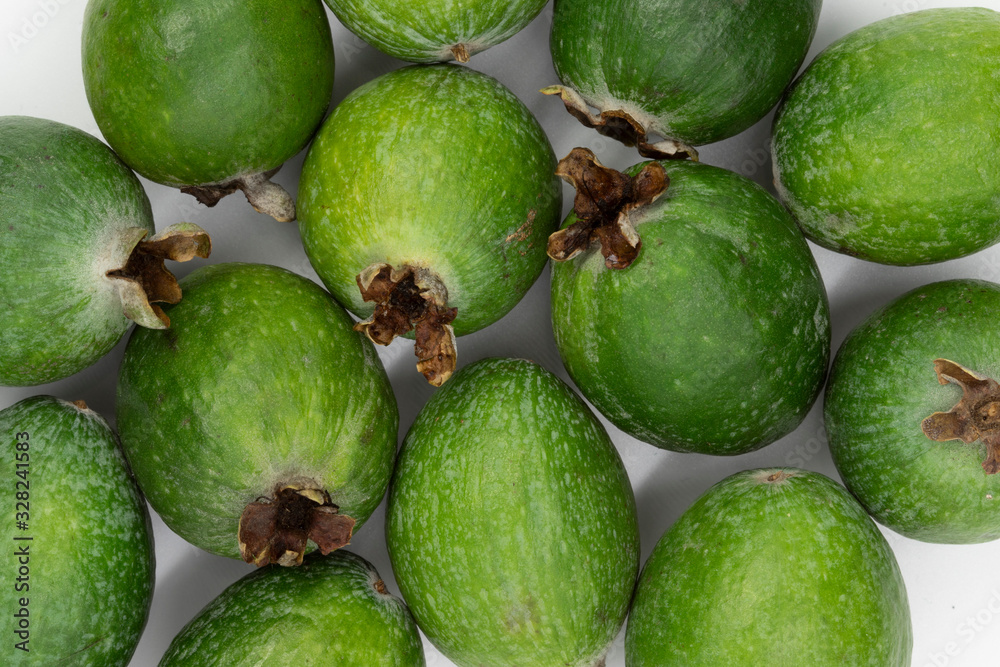 Green feijoa fruits isolated on white background. Scientific name Acca ...