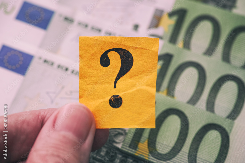 Person holds yellow paper note with question mark in his hand against ...