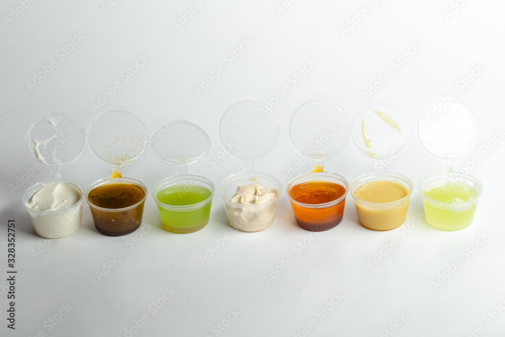 White isolated background, different types of sauces and colors in ...