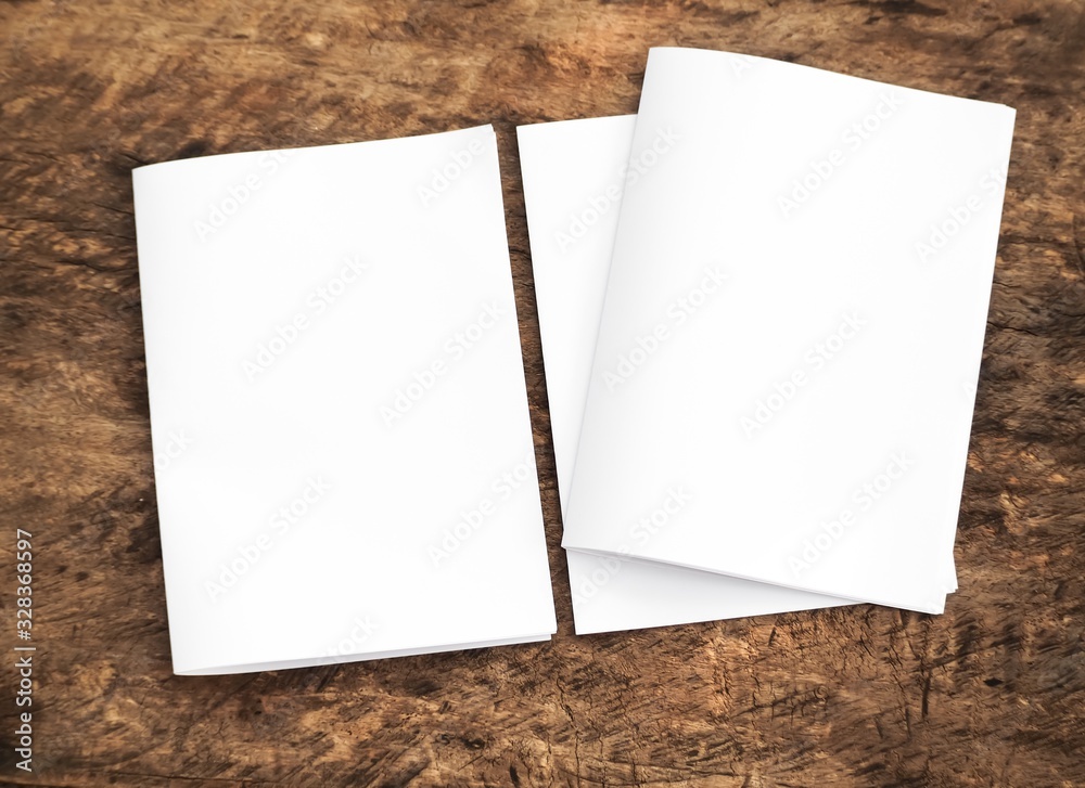 Blank portrait. white paper isolated on wood background. Poster mock ...