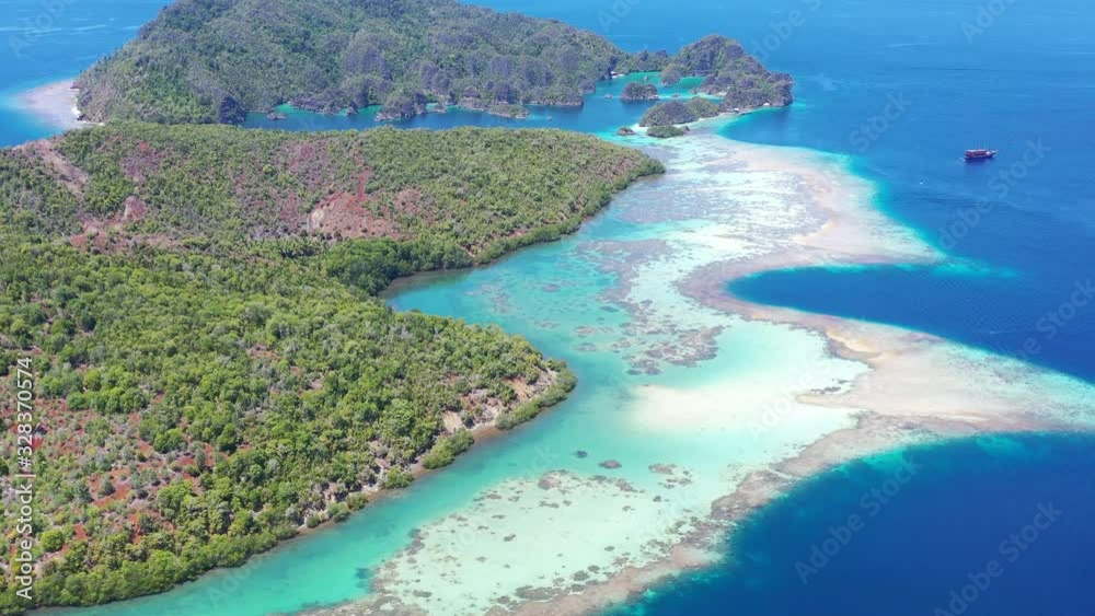 An aerial view shows a highly eroded and rugged islands of Penemu, Raja ...