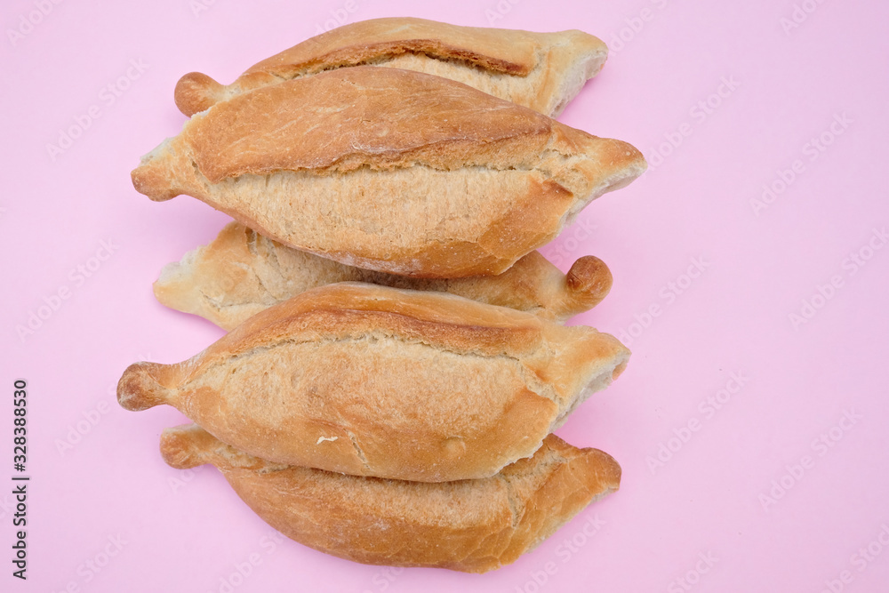 Mexican white bread, traditional Mexican baguette birote on a pastel ...