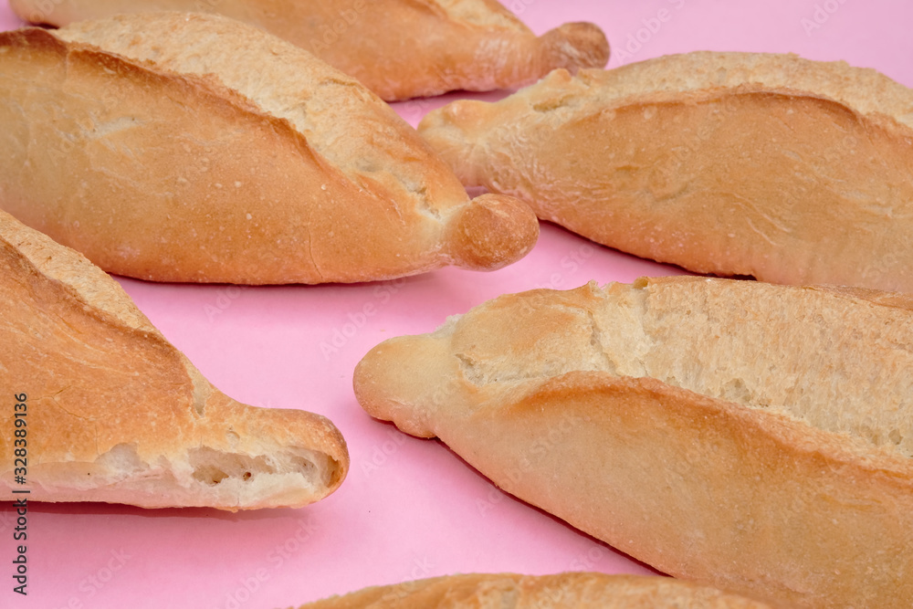 Mexican white bread, traditional Mexican baguette birote on a pastel ...