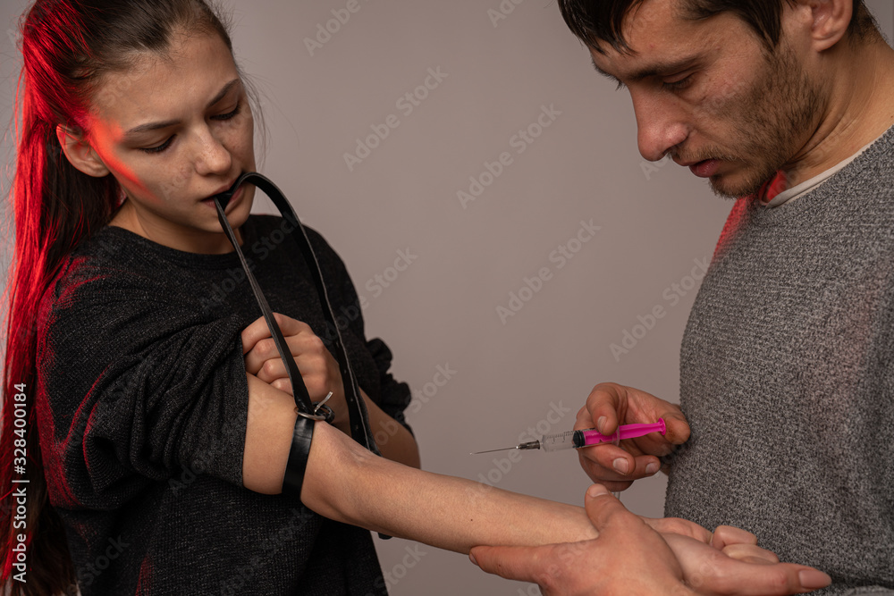 Junkie people using syringe injectiong narcotic illegal drugs ...