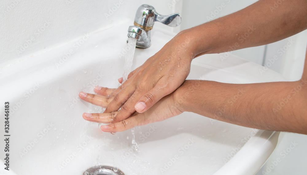 Hygiene concept. Washing hands with soap under the faucet with water ...