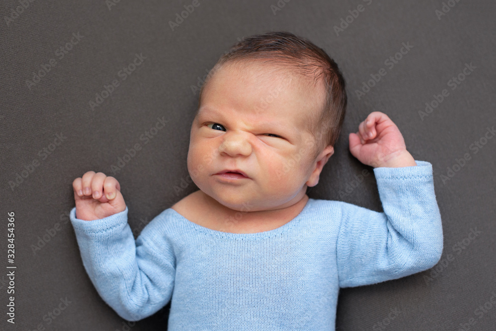 Newborn baby emotions, white background. Funny face of a child, emotions. Stock-Foto | Adobe Stock