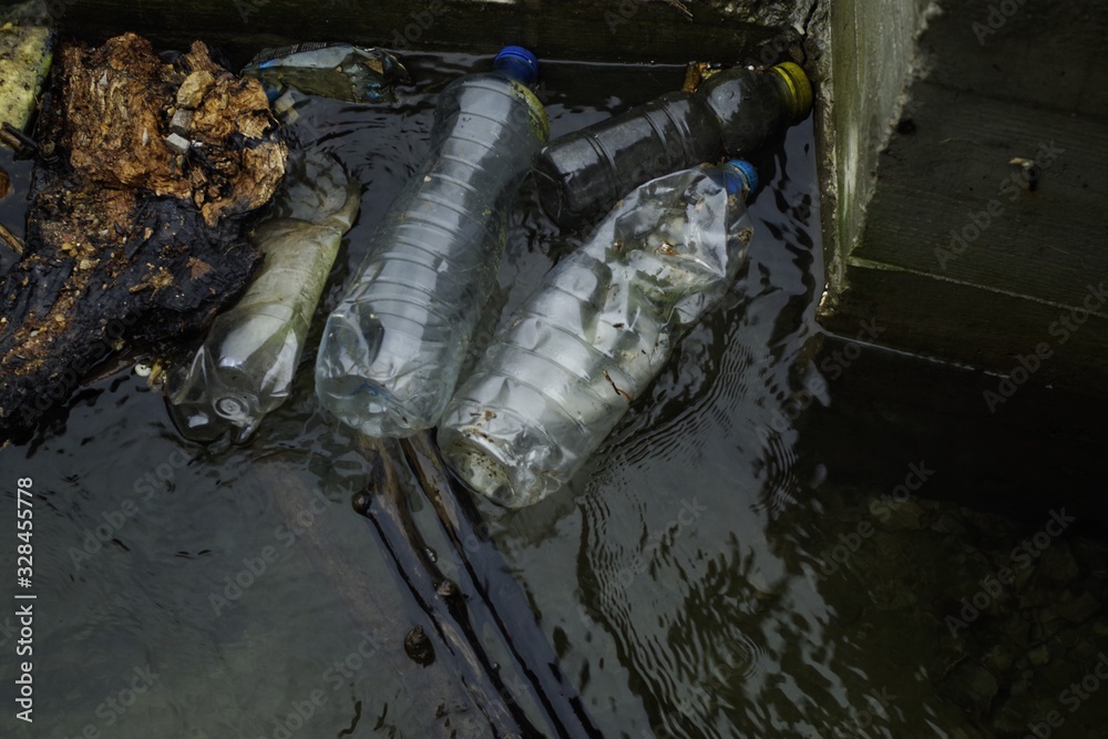 Water pollution. Plastic Bottles floating on a River Stock Photo ...