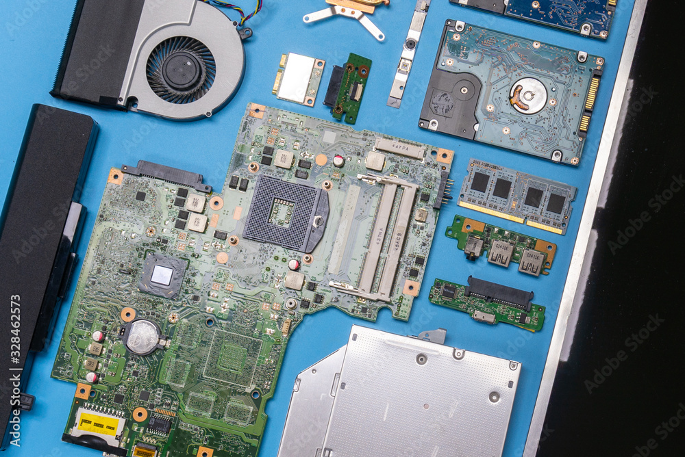 Parts of a modern computer. The insides of a laptop on a blue ...
