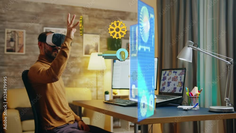 Engineer wearing a VR headset working in virtual space designing a new ...