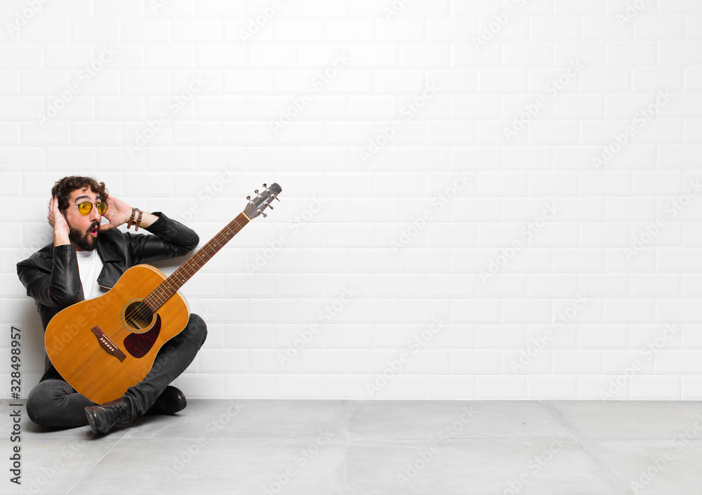 young musician man with open mouth, looking horrified and shocked ...