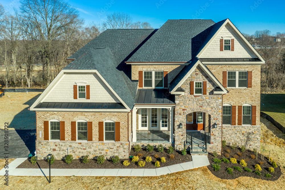 Aerial view of luxury single family mansion home covered w/ shingle ...