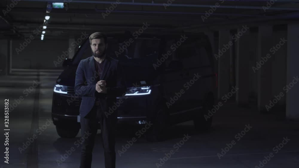 Police officer standing in front of his patrol car with siren glow ...