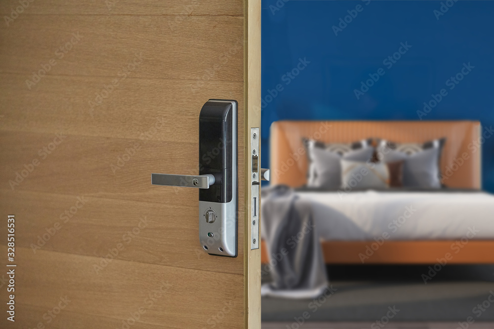 Digital door lock security systems on white wood door in front of blur ...
