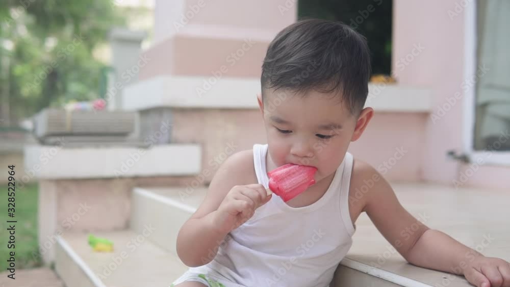 Slow motion Shallow depth of field video of a cute Asian boy calmly ...