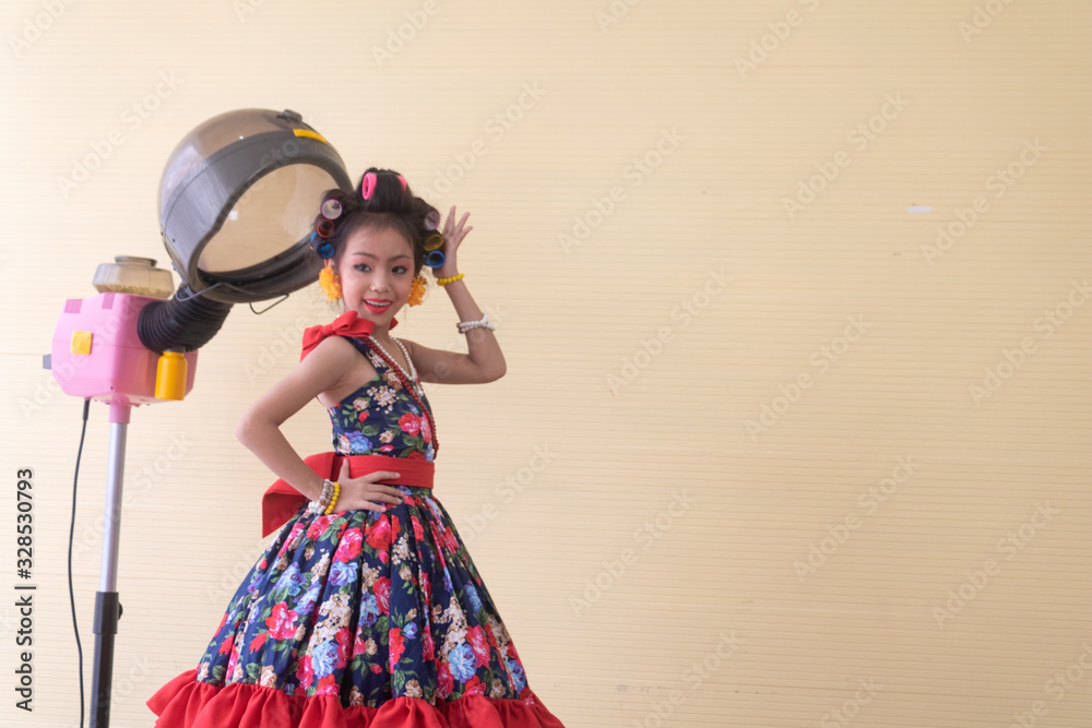 Beautiful little girl fashionista with roller hair She is very happy ...