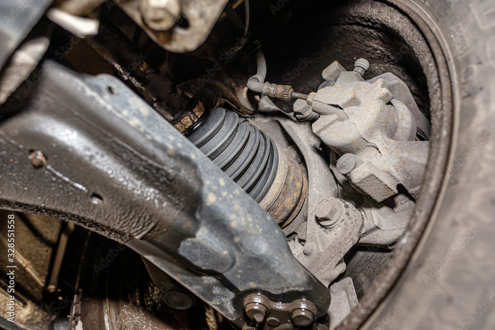 Front driving axle in the car, visible elements of the steering system ...