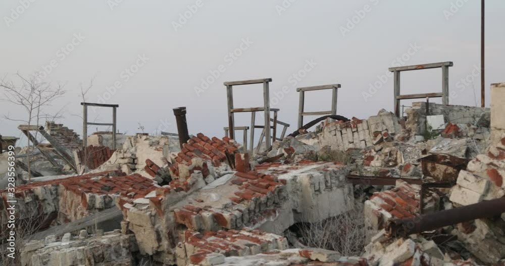 Panning through rubbled construction, detail of demolished concrete ...