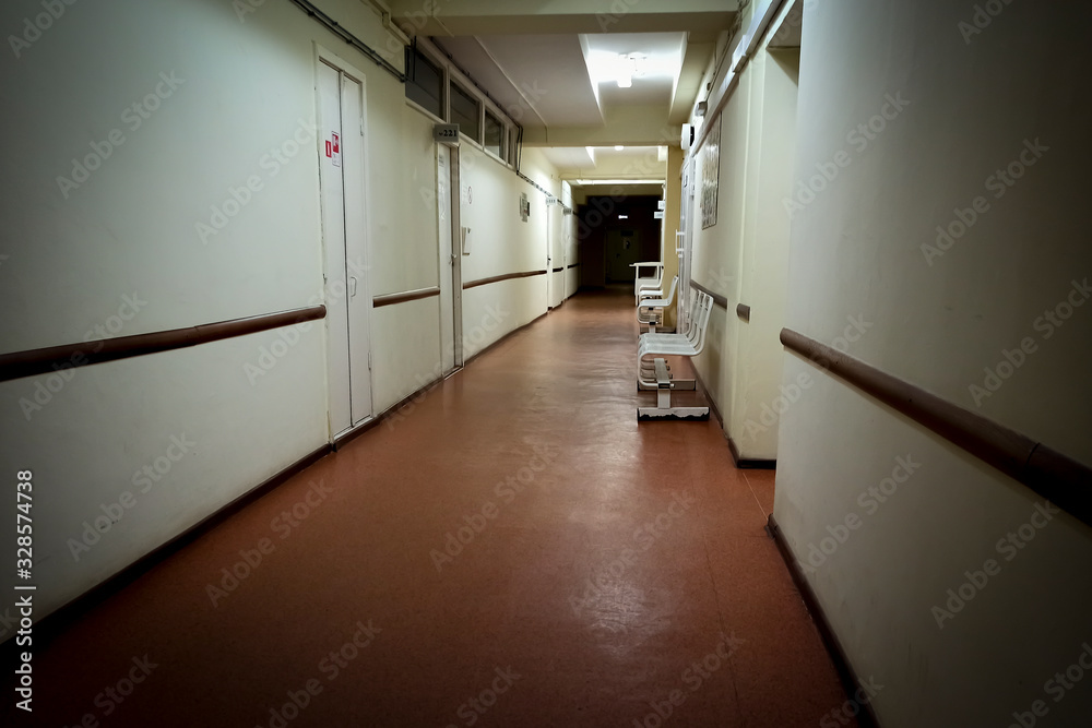 The gloomy corridor of the municipal budget hospital. Dark room ...