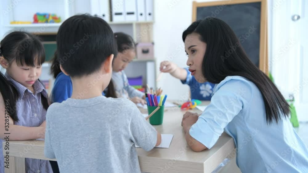 Educational concepts. The teacher is teaching kindergarten children to ...