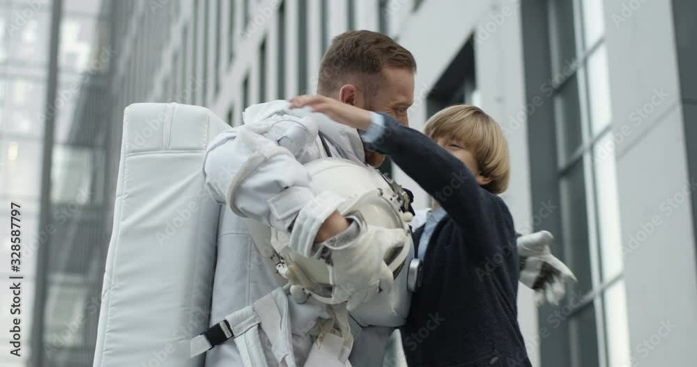 Spaceman father coming back home to his small cute son. Little ...