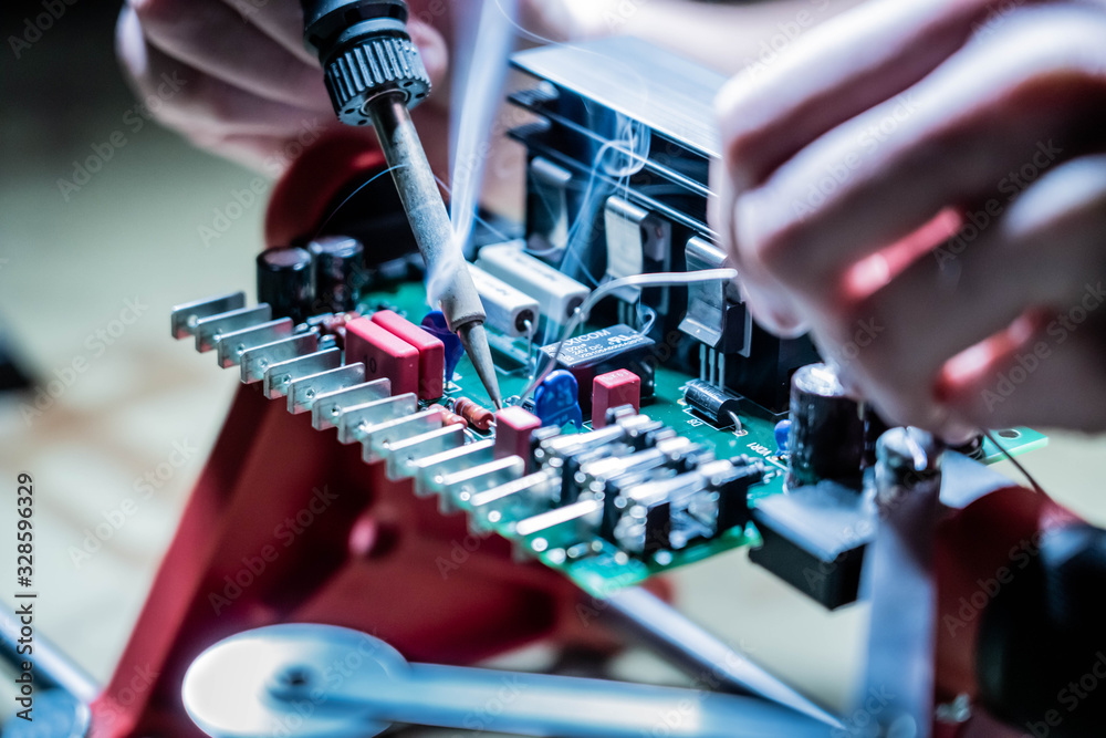 Engineer soldering a control board Stock Photo | Adobe Stock