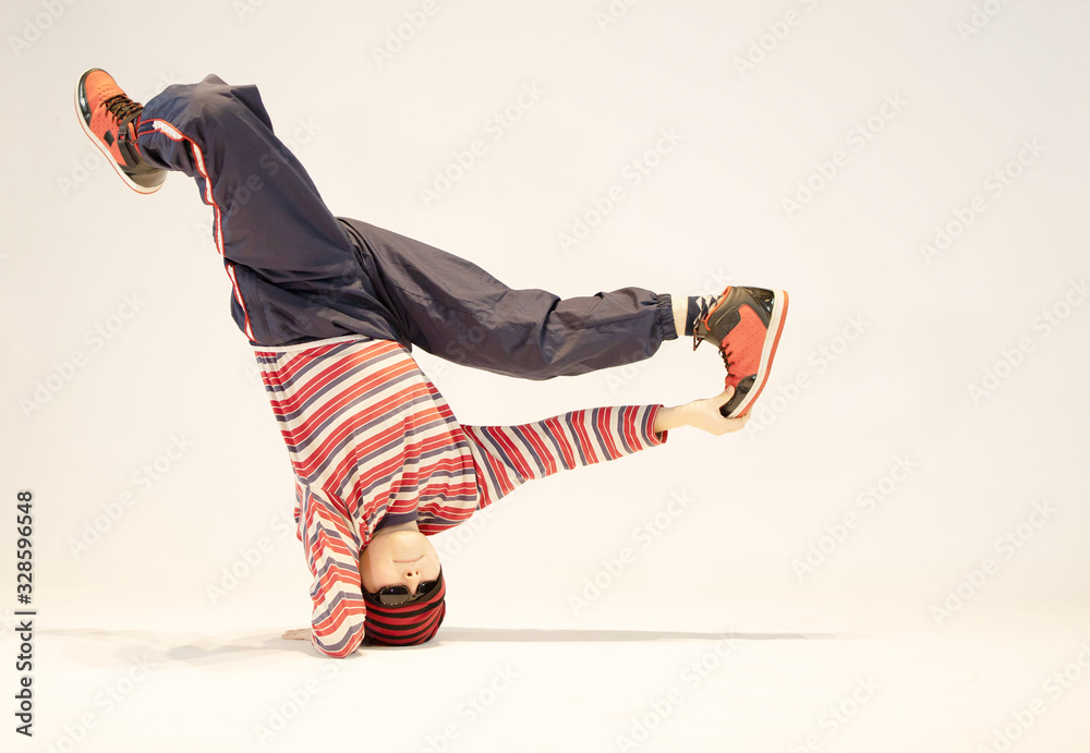 a little boy in a unique breakdance pose, a unique dance position, a ...