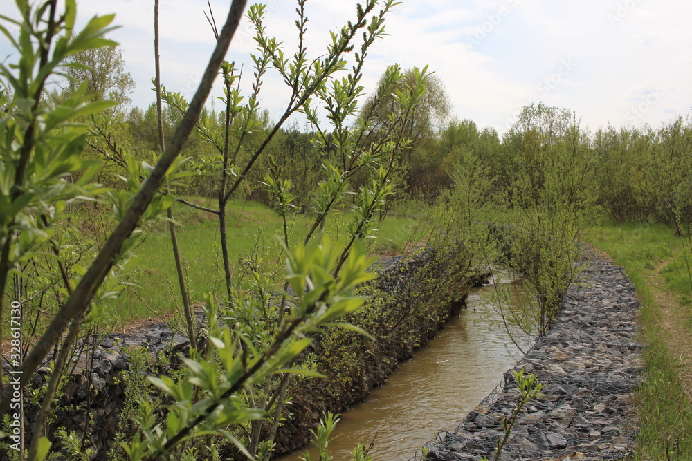 concrete channel with water river in the pipe flows stream artificial ...