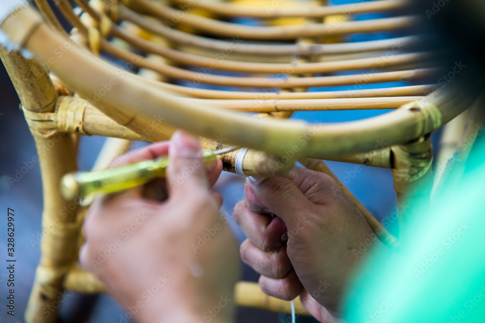 Restoration of rattan chair with white thread. Recycling, upcycling and ...