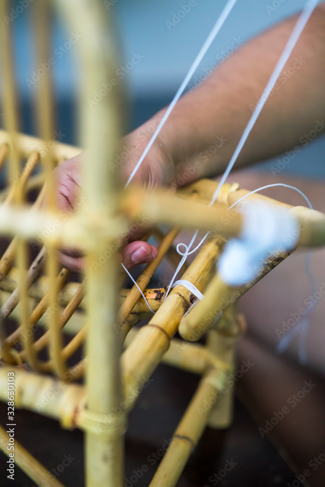 Restoration of rattan chair with white thread. Recycling, upcycling and ...
