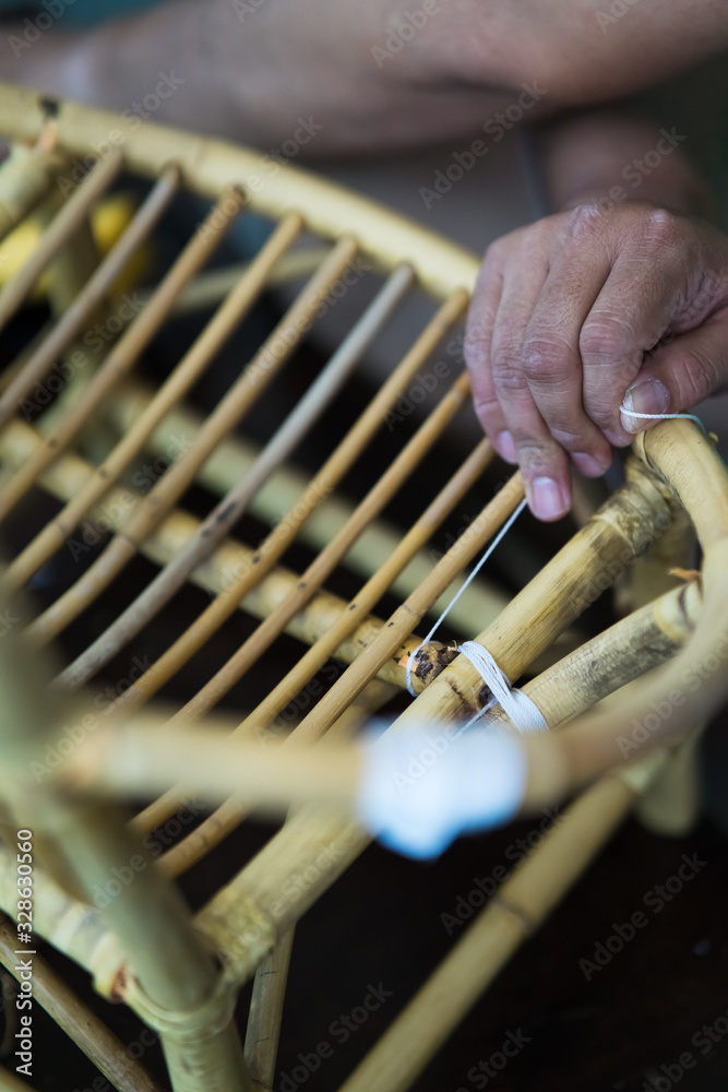 Restoration of rattan chair with white thread. Recycling, upcycling and ...