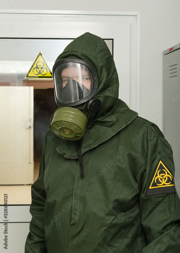 Men in a biohazard protective suit in laboratory. Protection against ...
