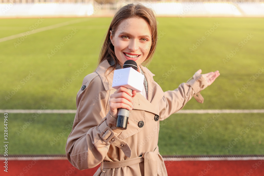 Beautiful reporter with microphone at the stadium Stock Photo | Adobe Stock