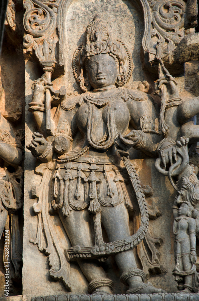 Carved idols on the outer wall of Hoysaleswara temple, is a 12th ...