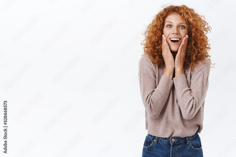 Fascinated, astonished redhead curly caucasian woman sighing from ...
